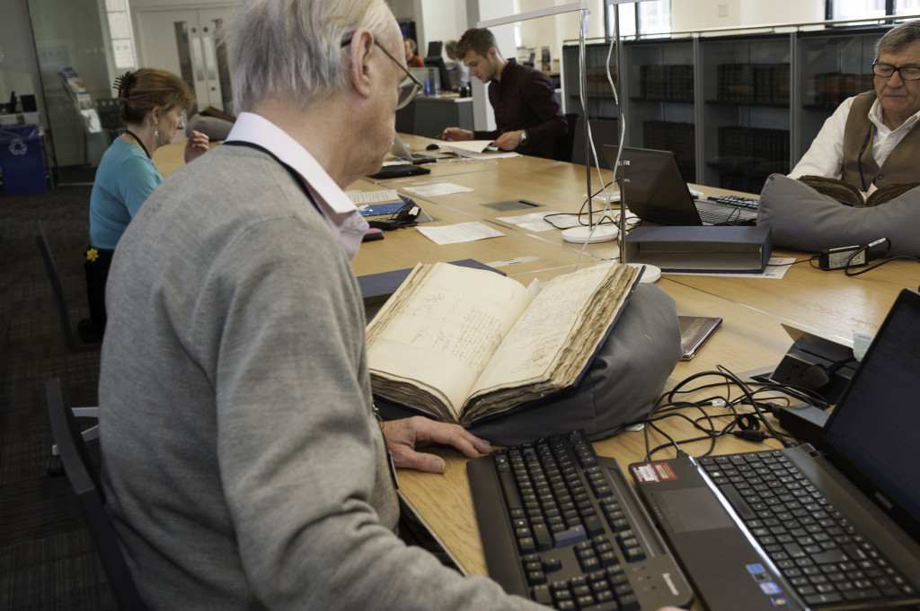 Caird Library images of Voluteers studing documents. Old and young ...